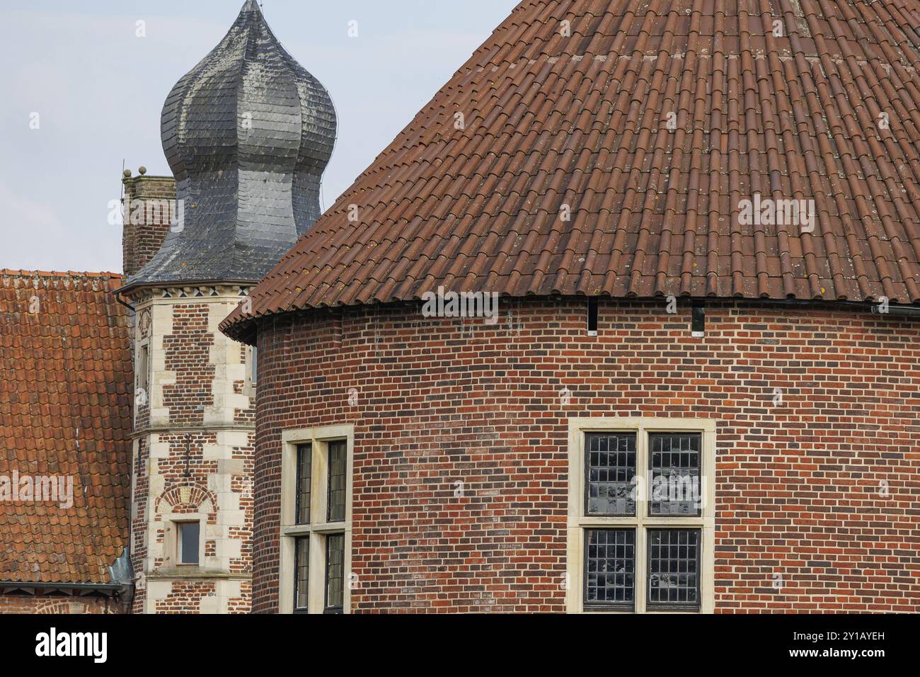 Large round roof on a brick building with historic tower and windows ...