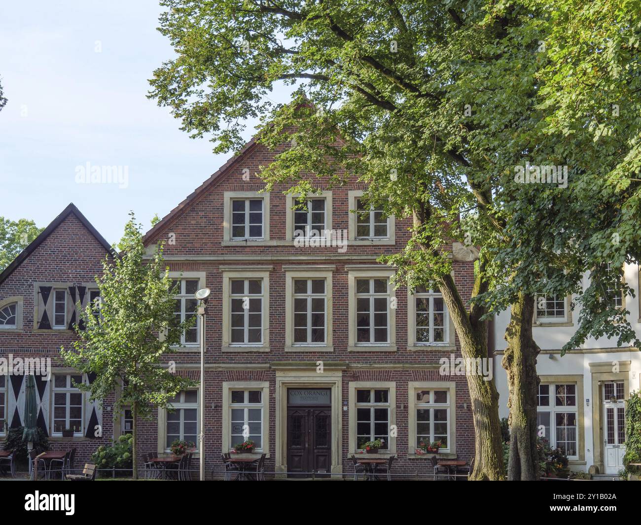 Romantic urban brick building surrounded by trees, Billerbeck ...