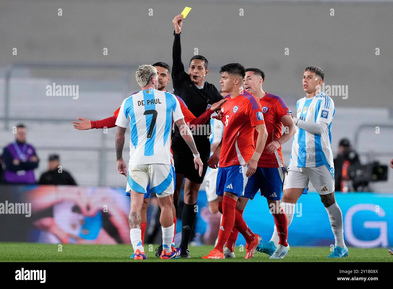 Referee Jesus Valenzuela shows the yellow card to Argentina's Rodrigo ...