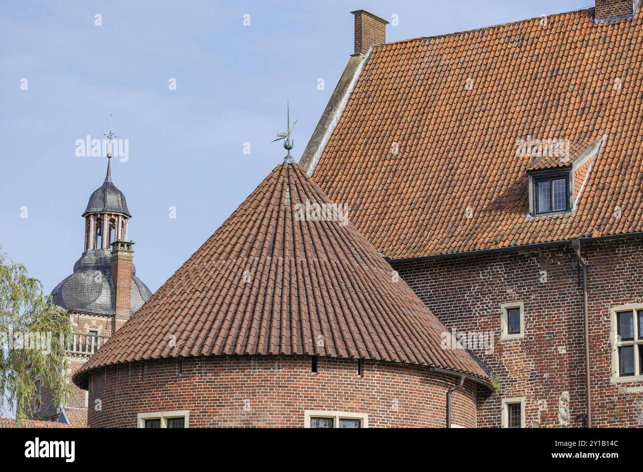 Historic round building with red tiled roofs and a tower in the ...