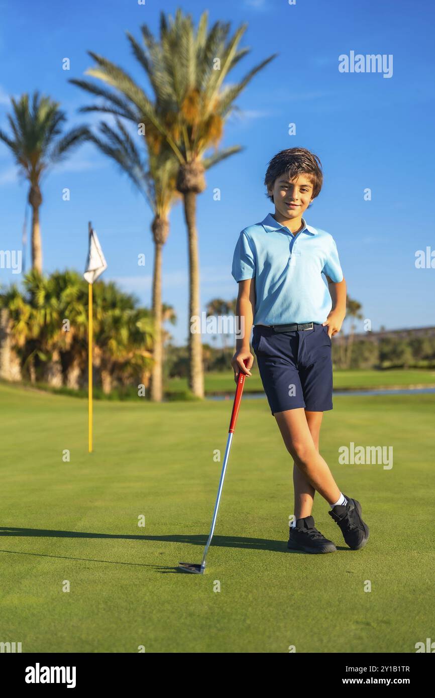 Vertical portrait with copy space of a caucasian boy with golf club ...