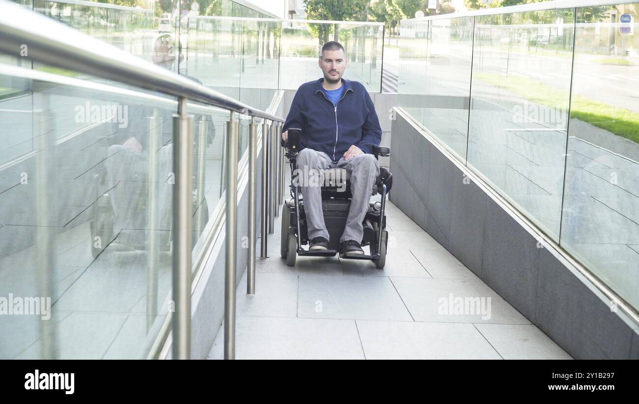 Man on electric wheelchair using a ramp. Accessibility concept Stock ...