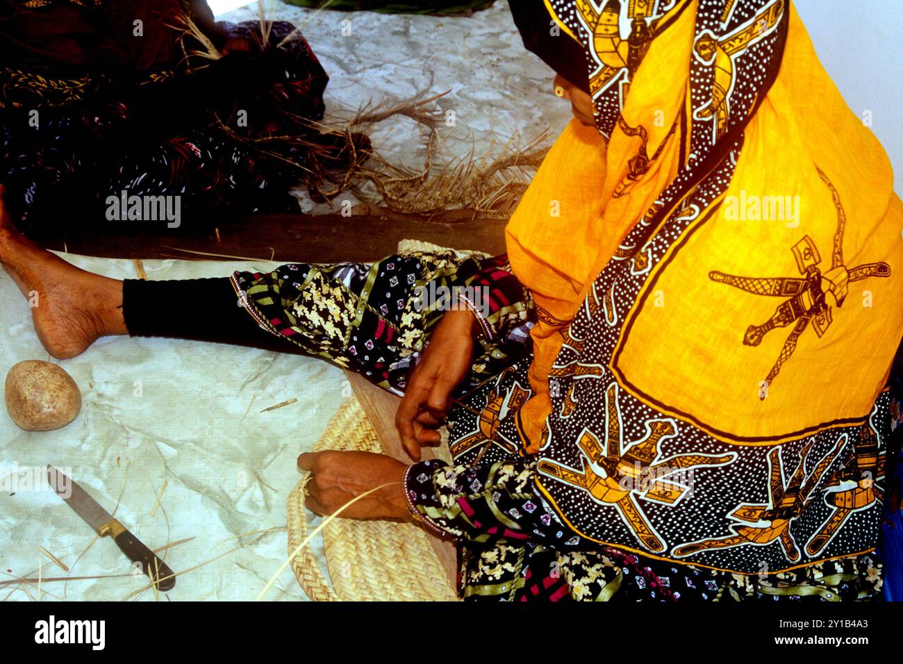 Omani woman weaving a palm leaf mat Salalah, capital of Dhofar province ...