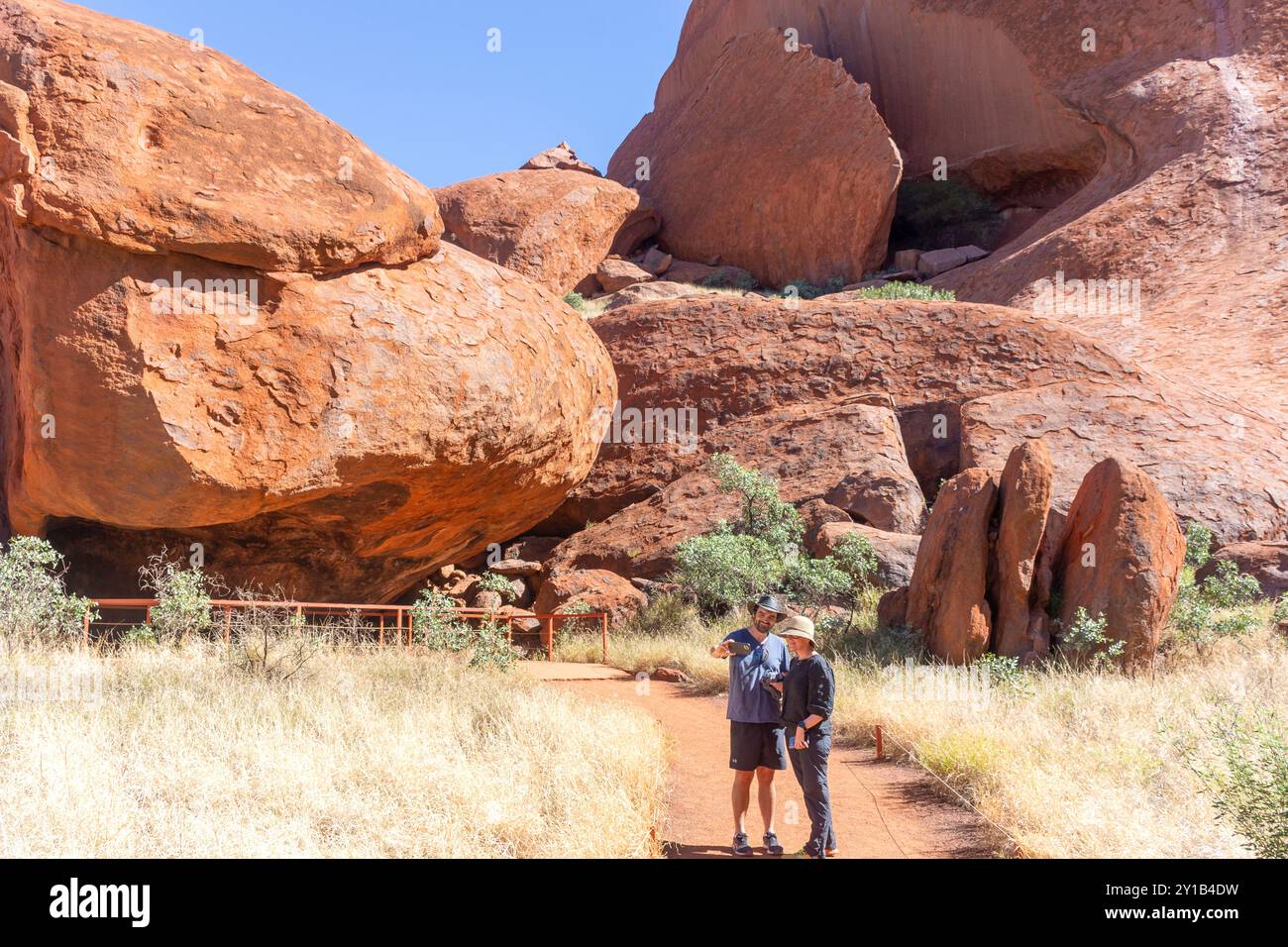 Tour group couple guide cave paintings kulpi mutitjulu cave mala hi-res ...