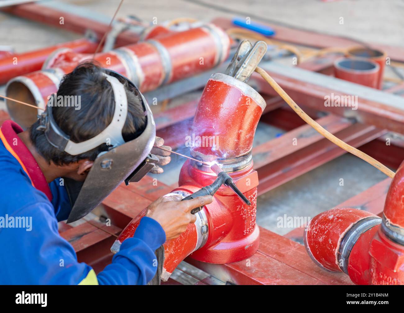 Welder is argon welding the metal tube in an industrail Stock Photo - Alamy