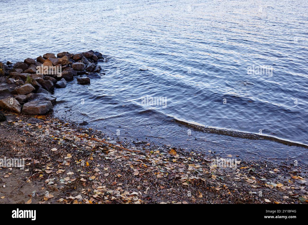 Water's edge on the shore at autumn. Wave of blue sea on beach ...