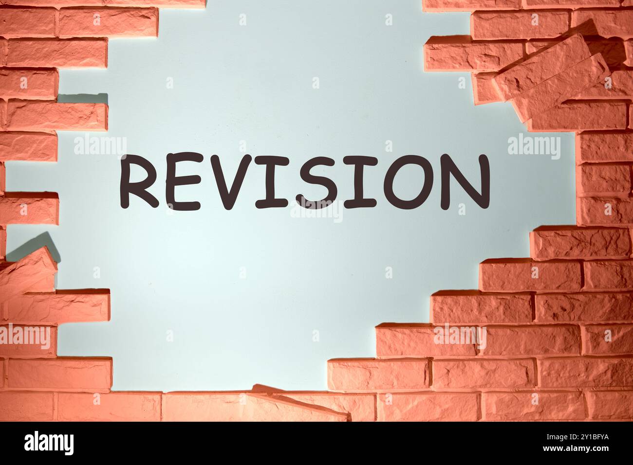 REVISION written on the wall under the dismantled bricks Stock Photo ...