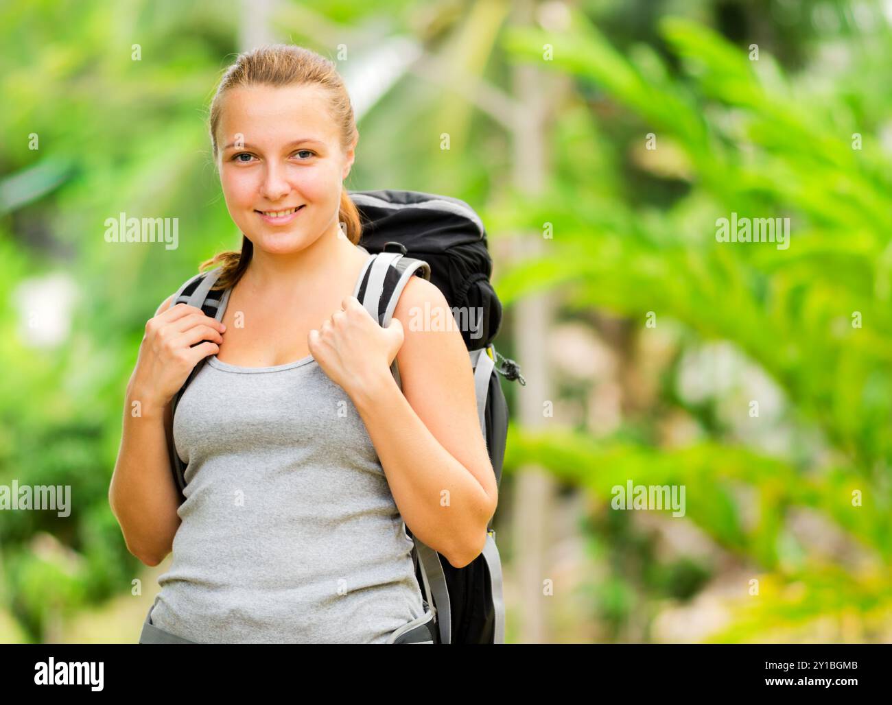Young woman with backpack in a woods. Hiking at summertime Stock Photo ...