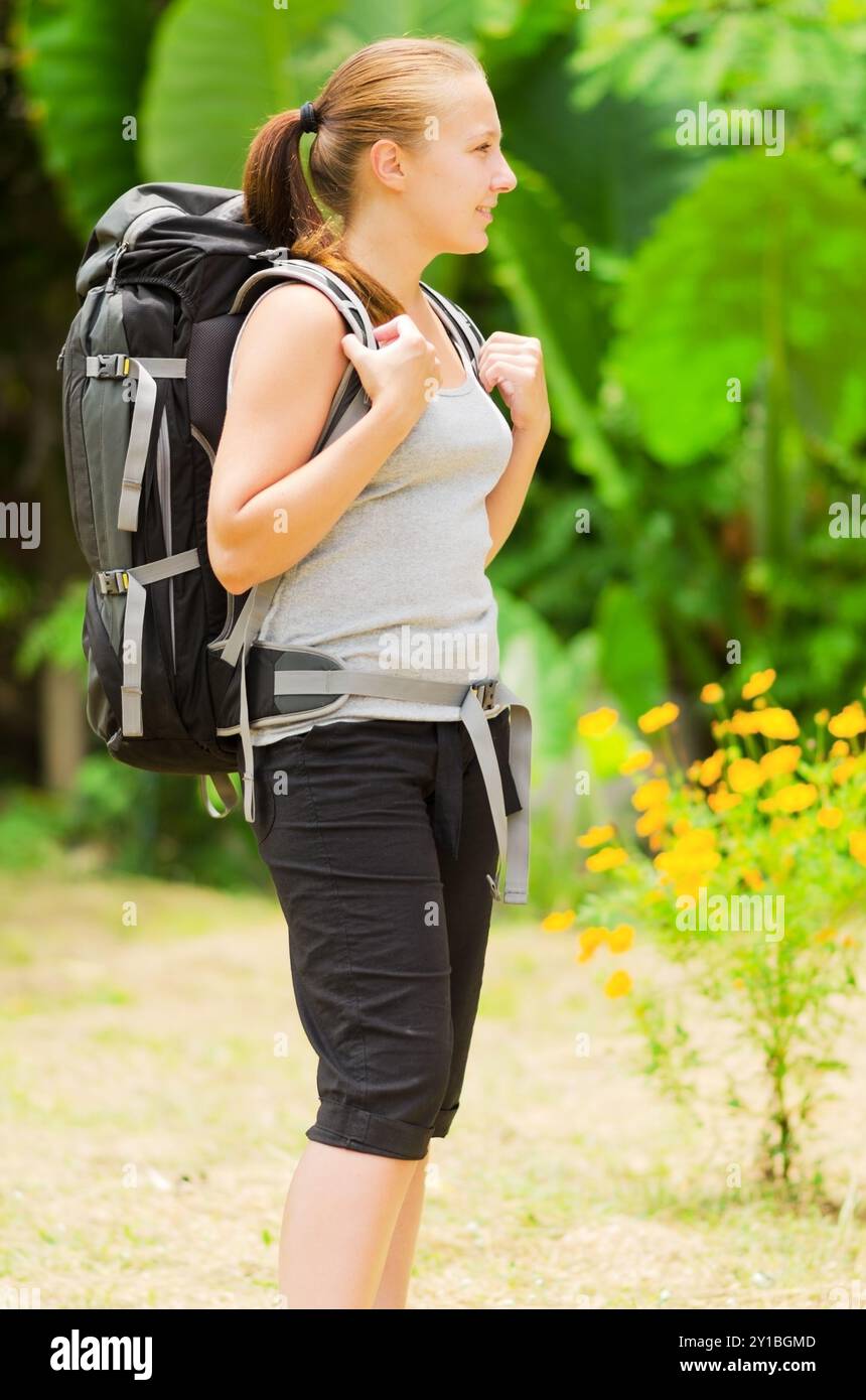Young woman with backpack in a woods. Hiking at summertime Stock Photo ...