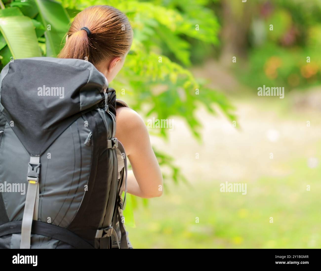 Young woman with backpack in a woods. Hiking at summertime Stock Photo ...