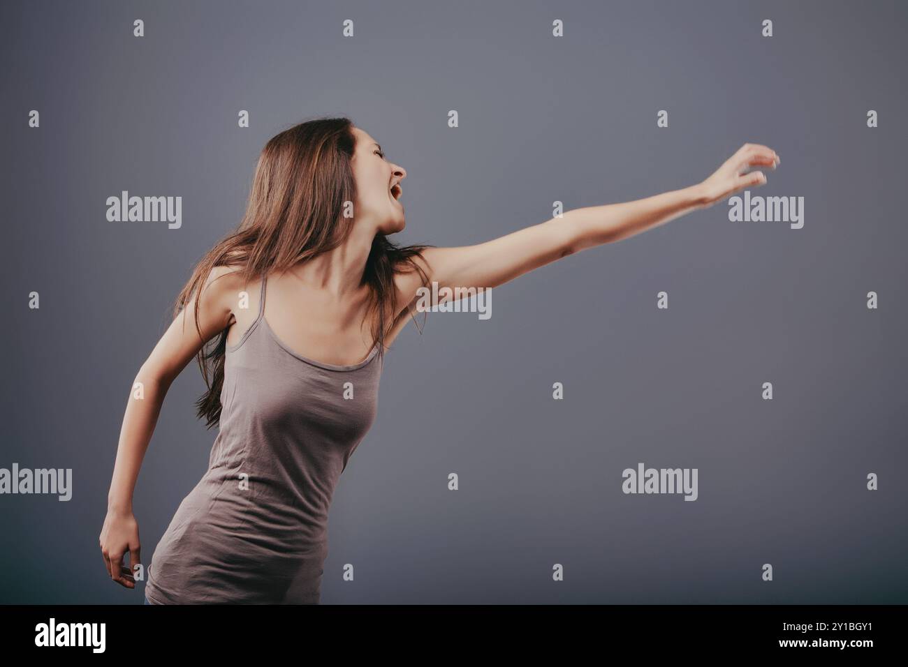 woman with long brown hair extends her arm desperately, reaching toward ...