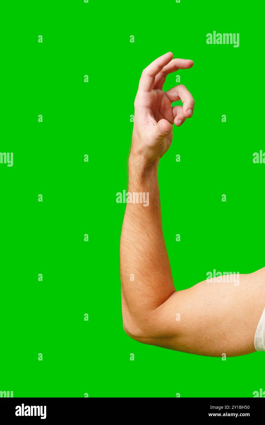 Hand Gesture Above Arm Against Bright Green Background Stock Photo - Alamy
