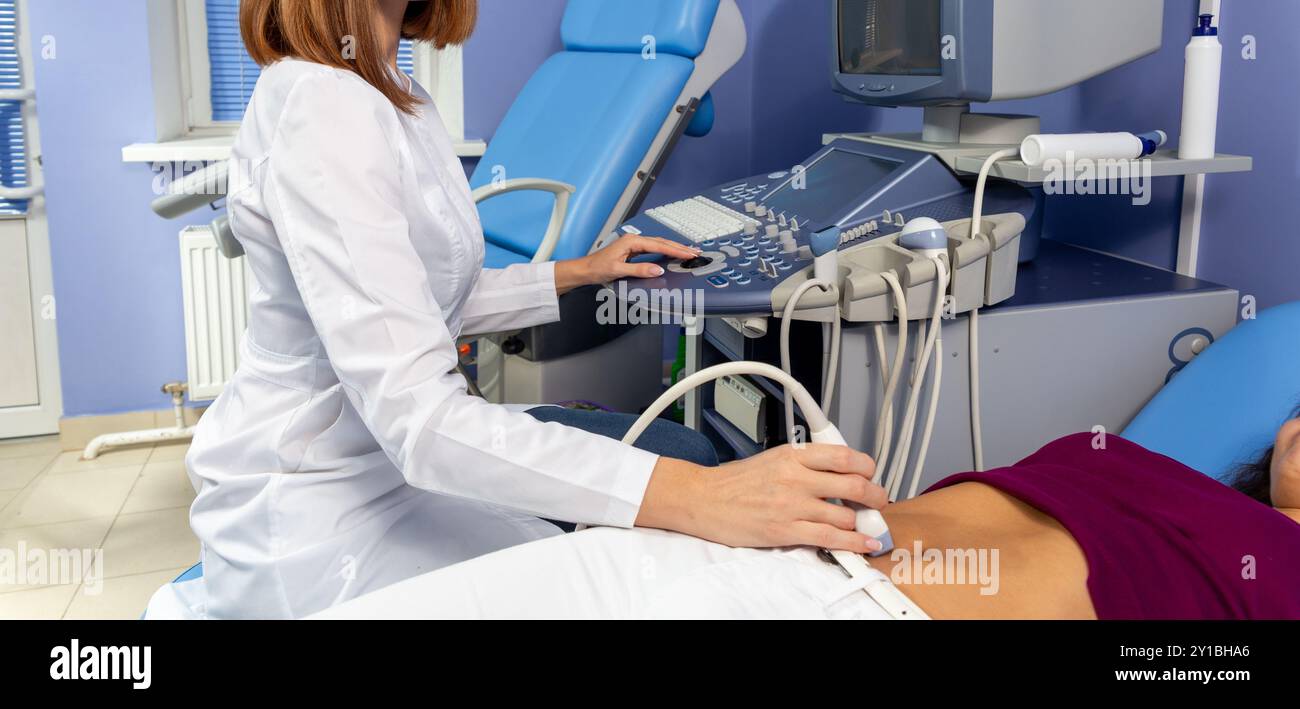 The doctor performs an ultrasound diagnosis of the abdominal cavity of ...
