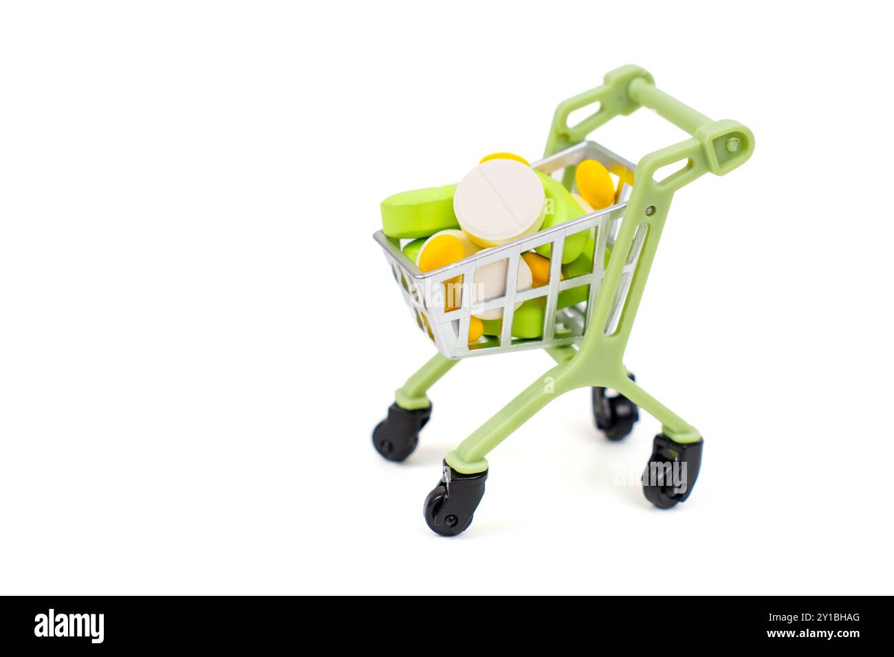 Tiny shopping cart loaded with vibrant pills and capsules isolated on ...