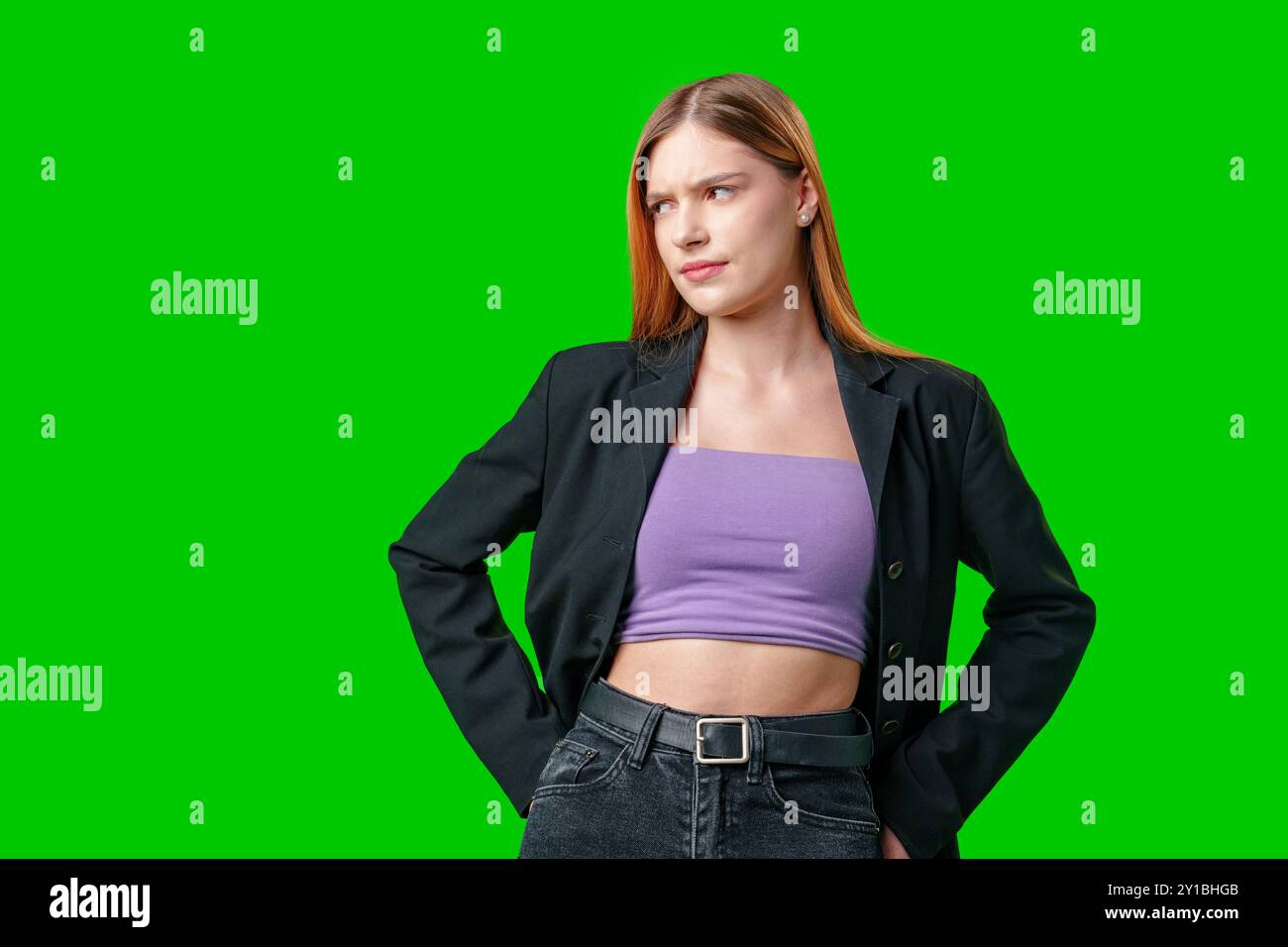 Young Woman With Serious Expression Against Green Screen Stock Photo ...