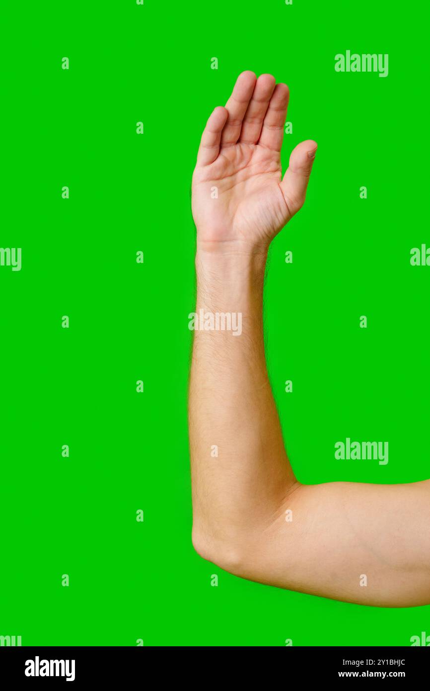 Hand Gesture Above Arm Against Bright Green Background Stock Photo - Alamy
