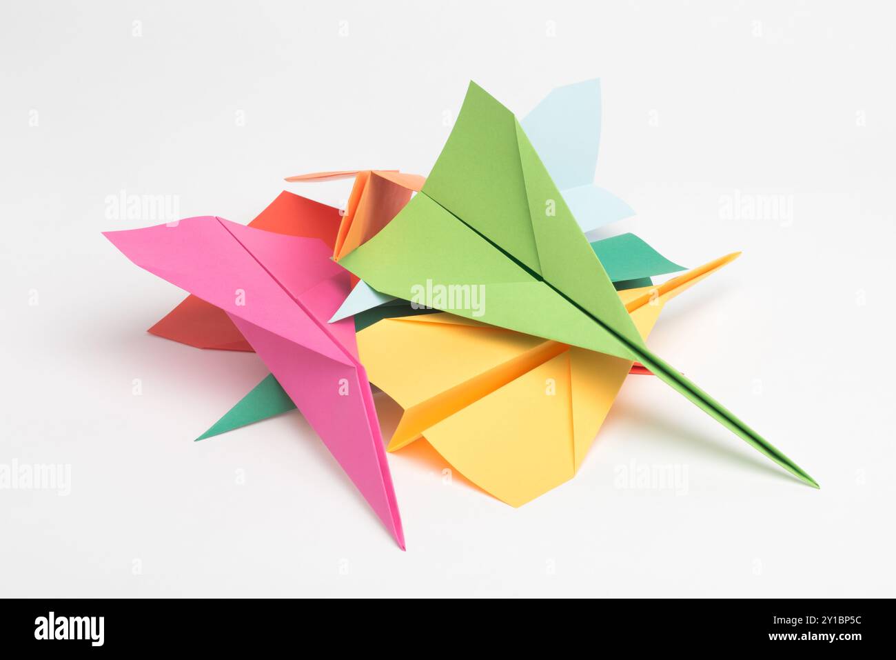 Paper, creative and colorful with plane in studio for artistic ...