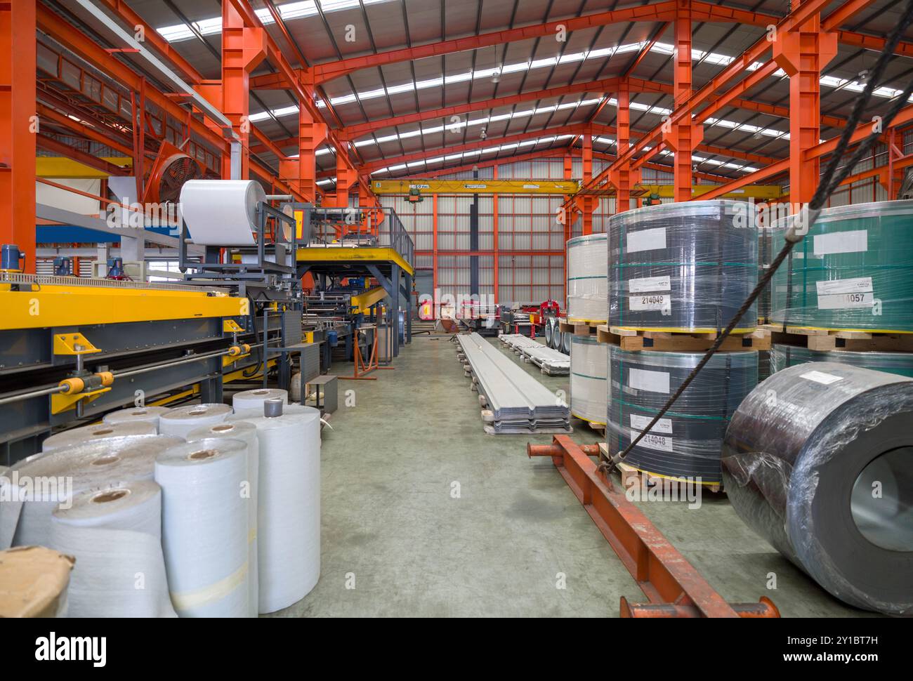 A gargantuan warehouse brims with a labyrinth of gleaming steel beams ...