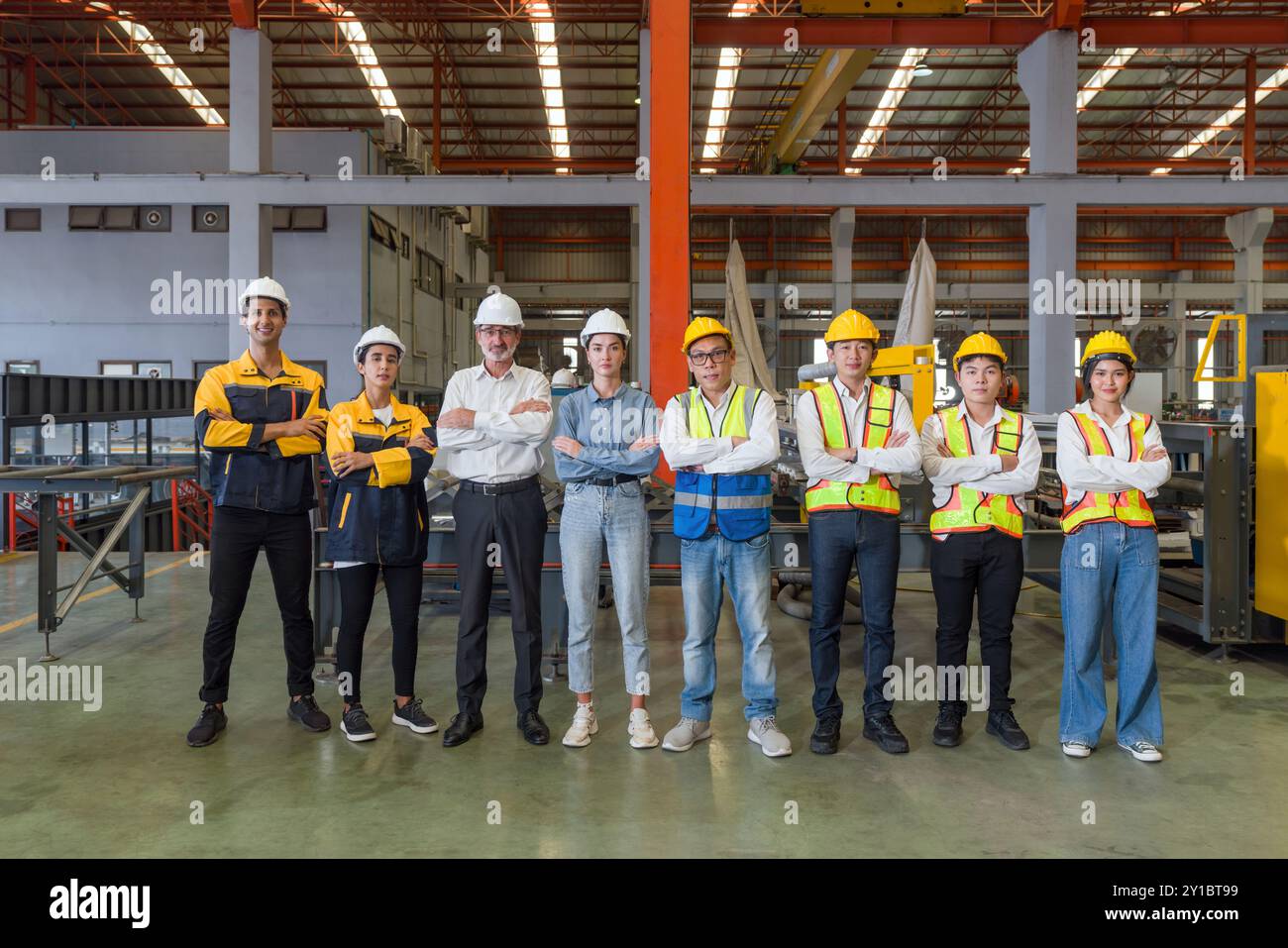 Group of male and female factory labor stand together with arms crossed ...