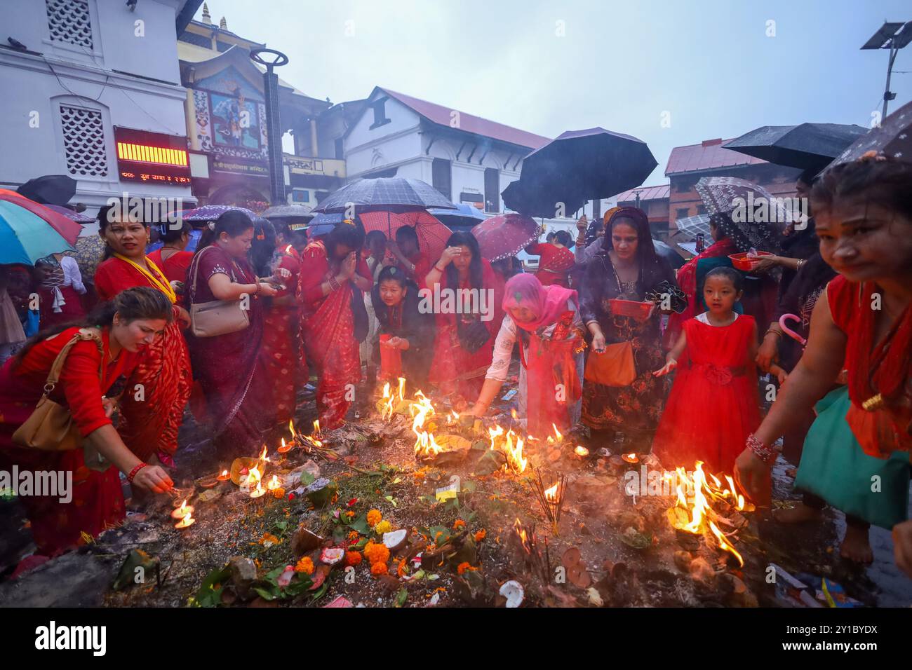 Fasting Nepali Hindu women light oil-fed lamps and incense sticks in ...