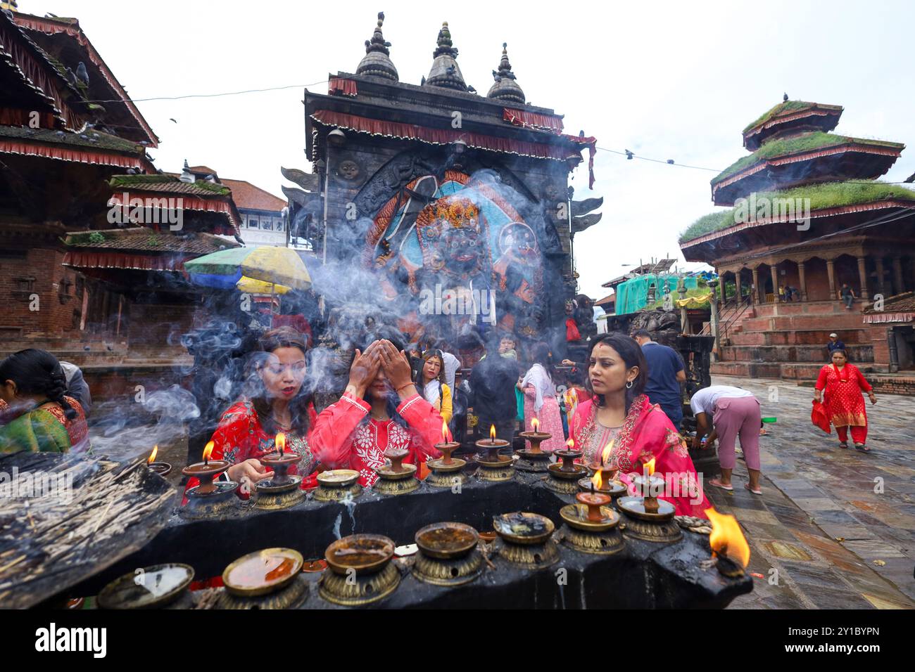 Fasting Nepali Hindu women perform rituals in front of Kaal Bhairav in ...