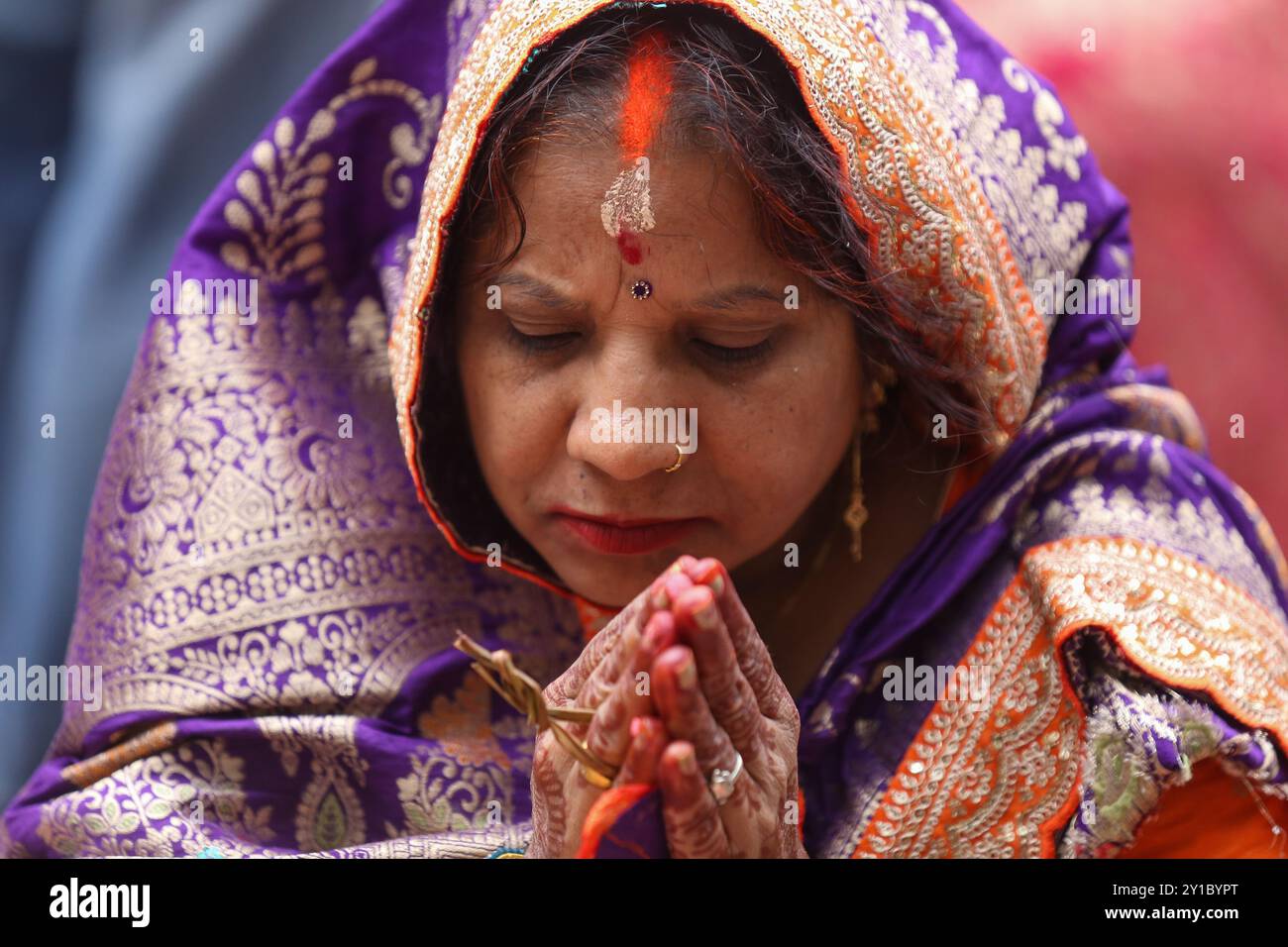 A fasting Nepali Hindu woman prays while performing rituals at a Shiva ...