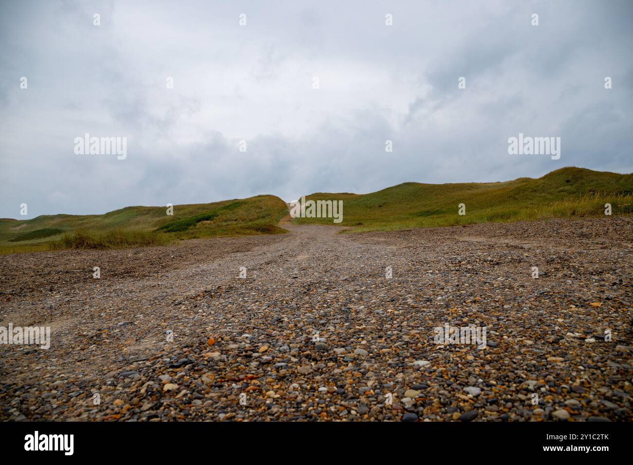 Wet gravel path up to a dune path in Denmark Stock Photo - Alamy