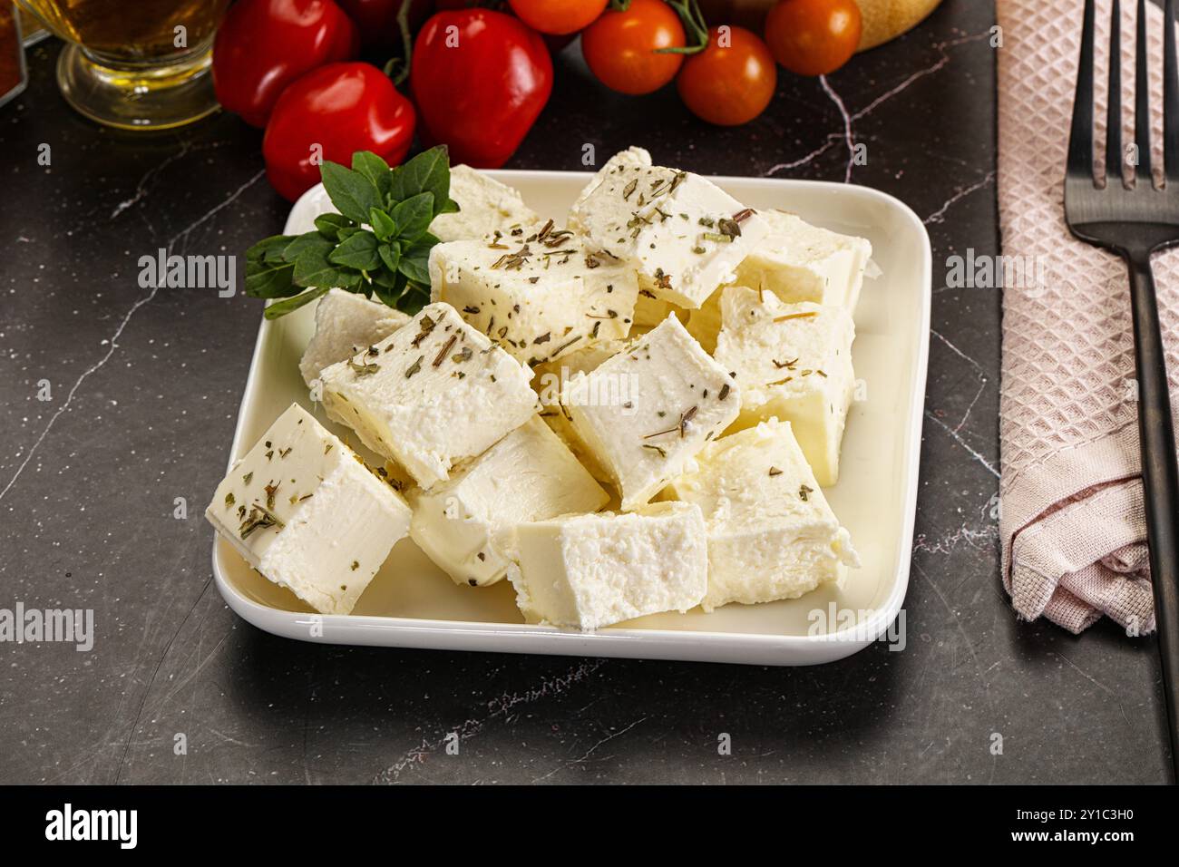 Greek traditional Feta cheese cubes with herbs and spices Stock Photo ...