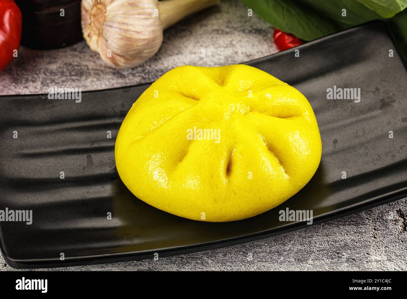 Asian stuffed steamed yellow Bun Bao Stock Photo - Alamy