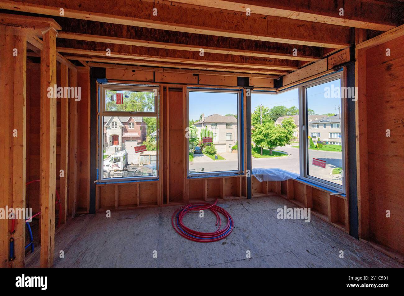 Installing European style windows in a house construction site, Toronto ...