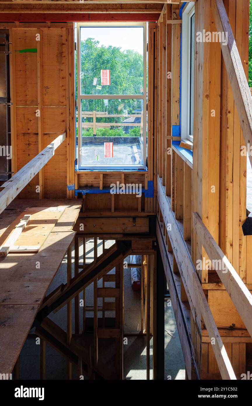 Installing European style windows in a house construction site, Toronto ...