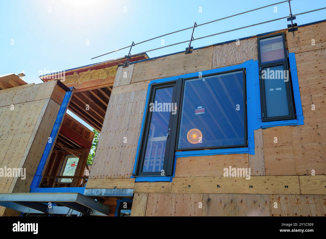 Installing European style windows in a house construction site, Toronto ...