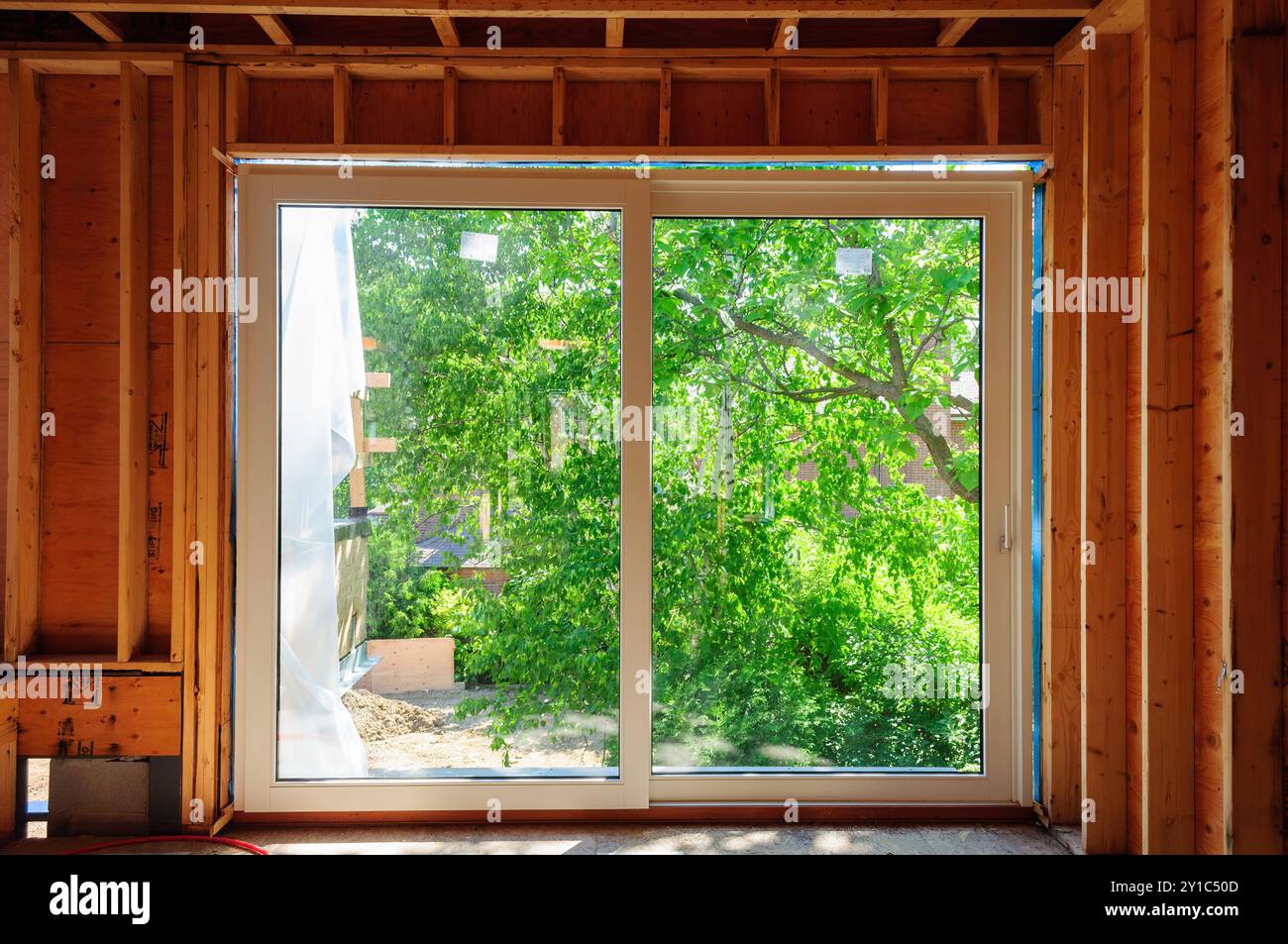 Installing European style windows in a house construction site, Toronto ...
