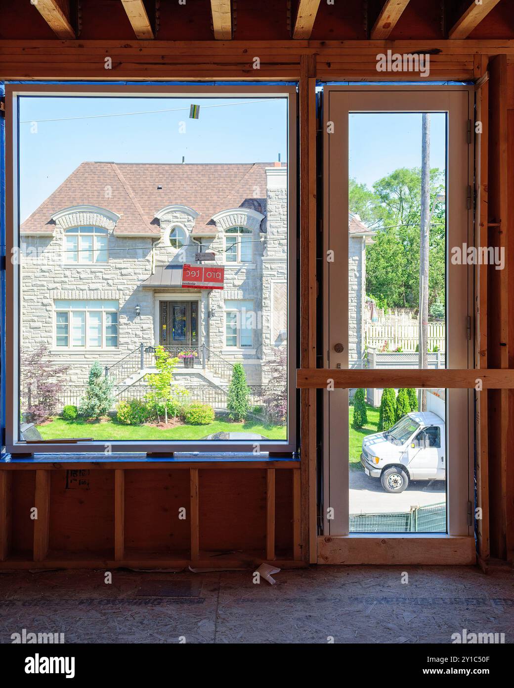 Installing European style windows in a house construction site, Toronto ...