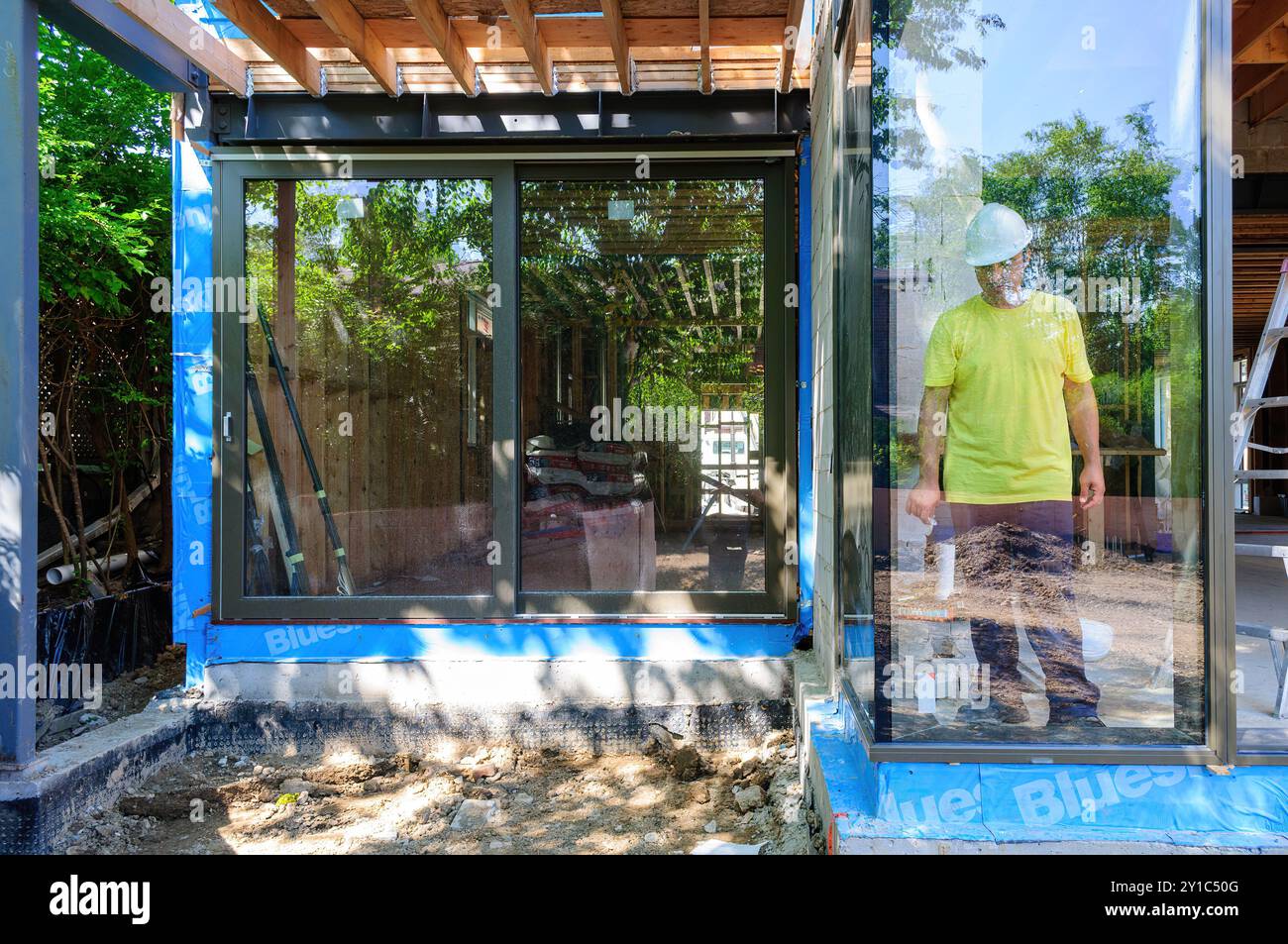 Installing European style windows in a house construction site, Toronto ...