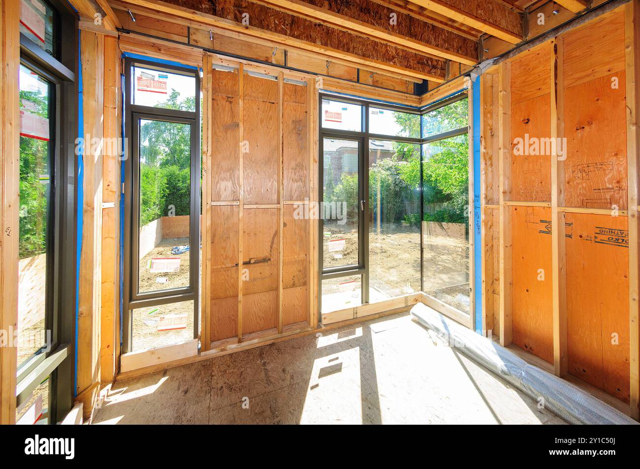 Installing European style windows in a house construction site, Toronto ...