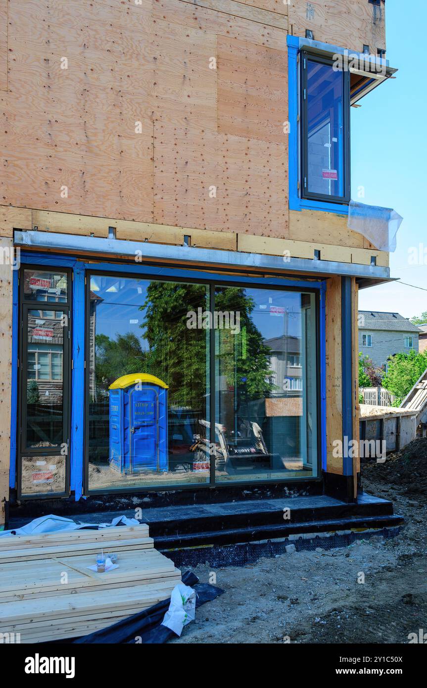 Installing European style windows in a house construction site, Toronto ...