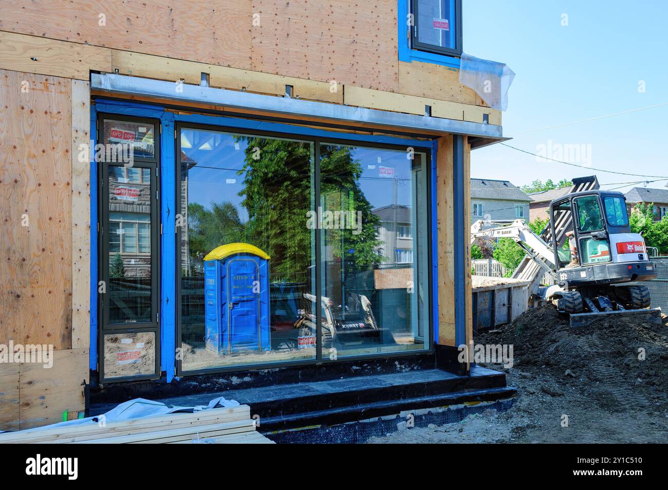 Installing European style windows in a house construction site, Toronto ...