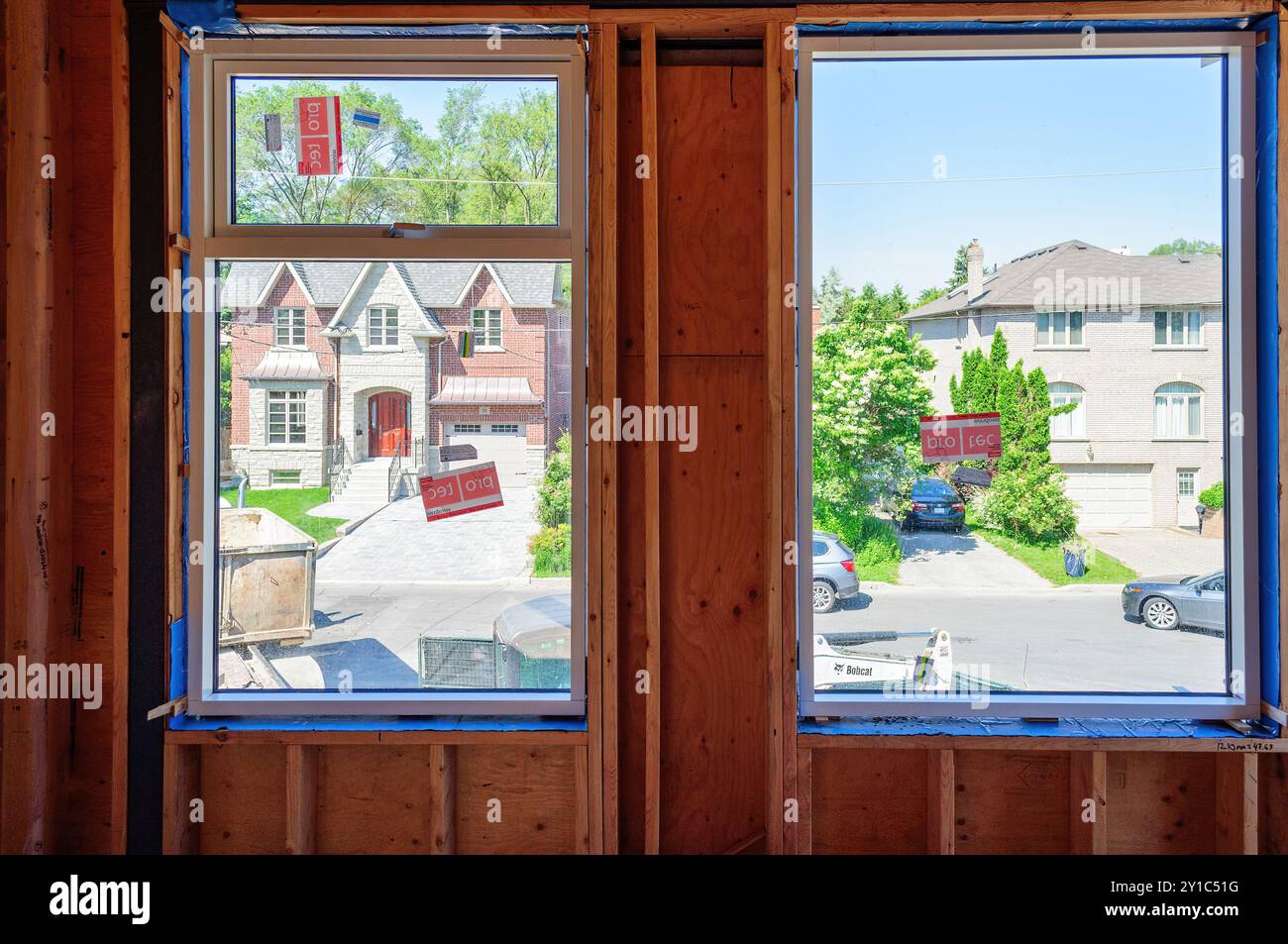 Installing European style windows in a house construction site, Toronto ...