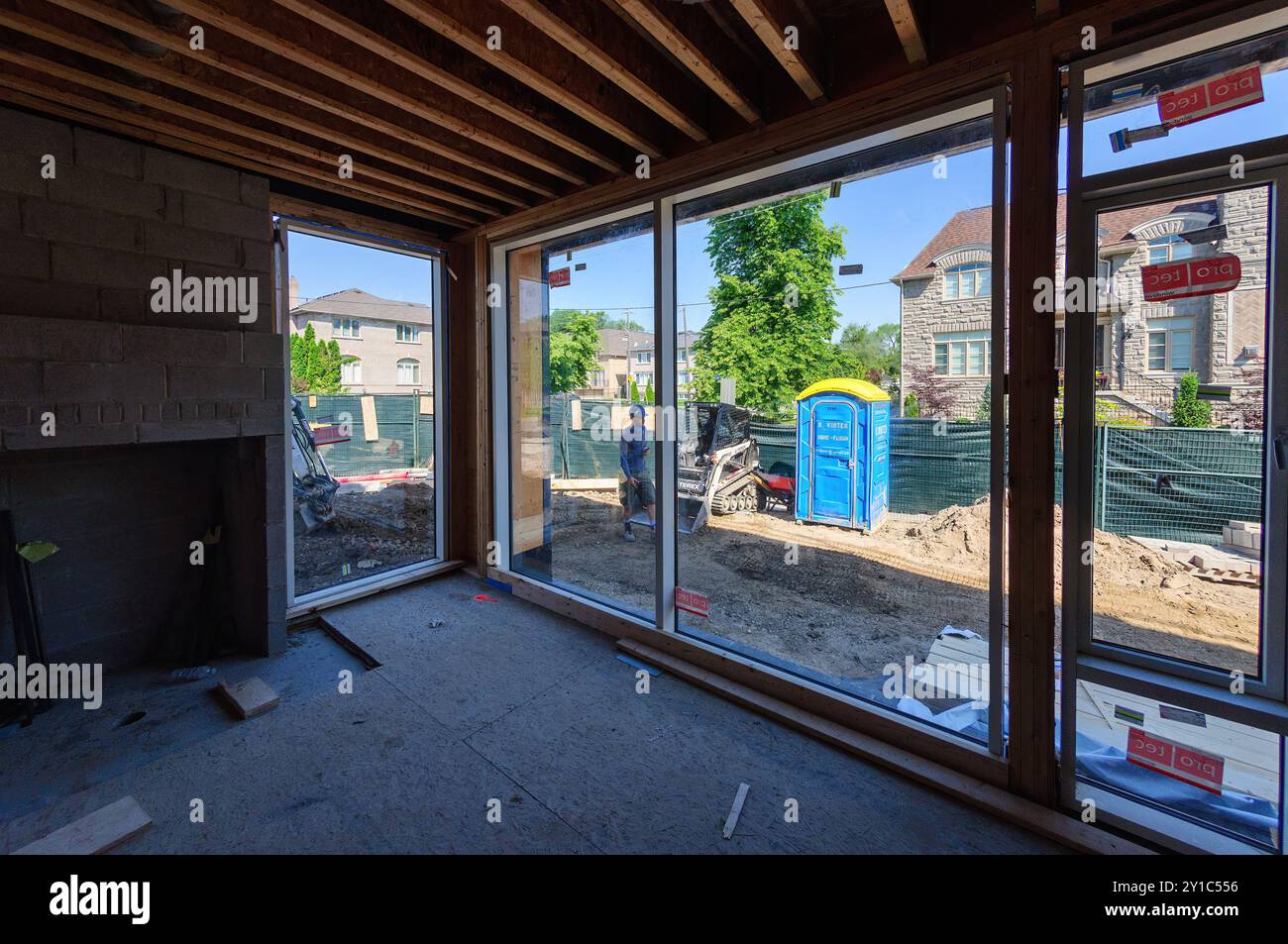 Installing European style windows in a house construction site, Toronto ...
