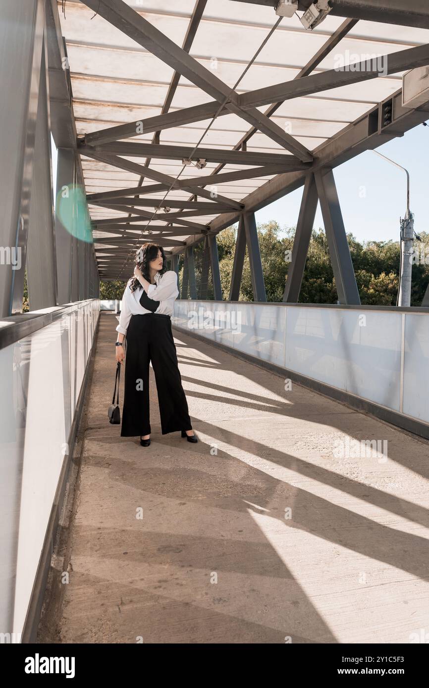 Stylish Woman Posing on Modern Steel Walkway Bridge in Urban Setting ...