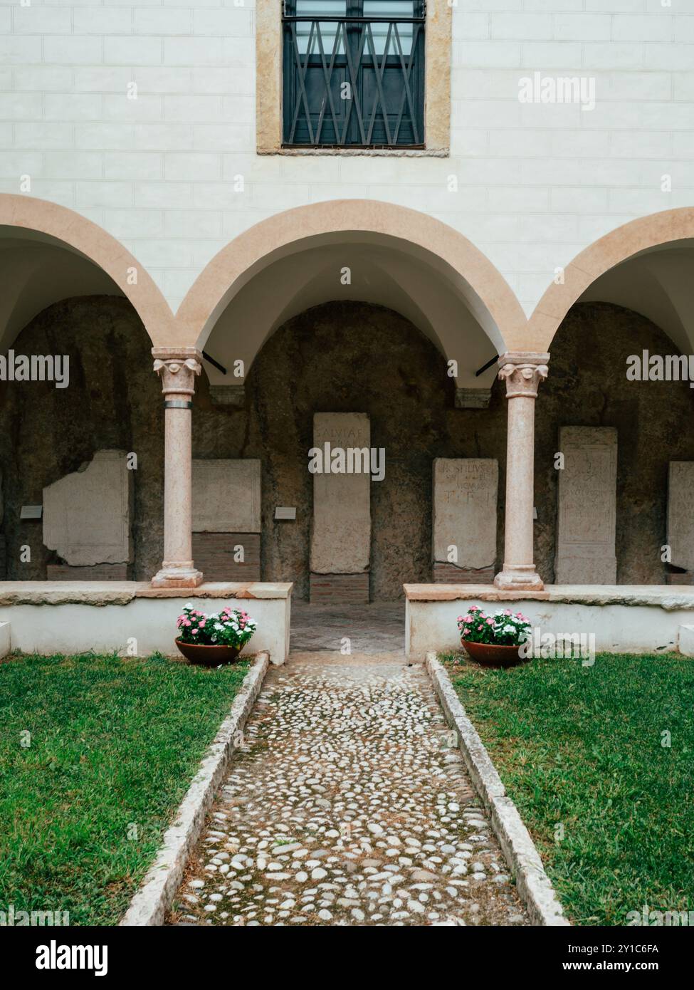 A peaceful courtyard features ancient stone inscriptions arranged along ...