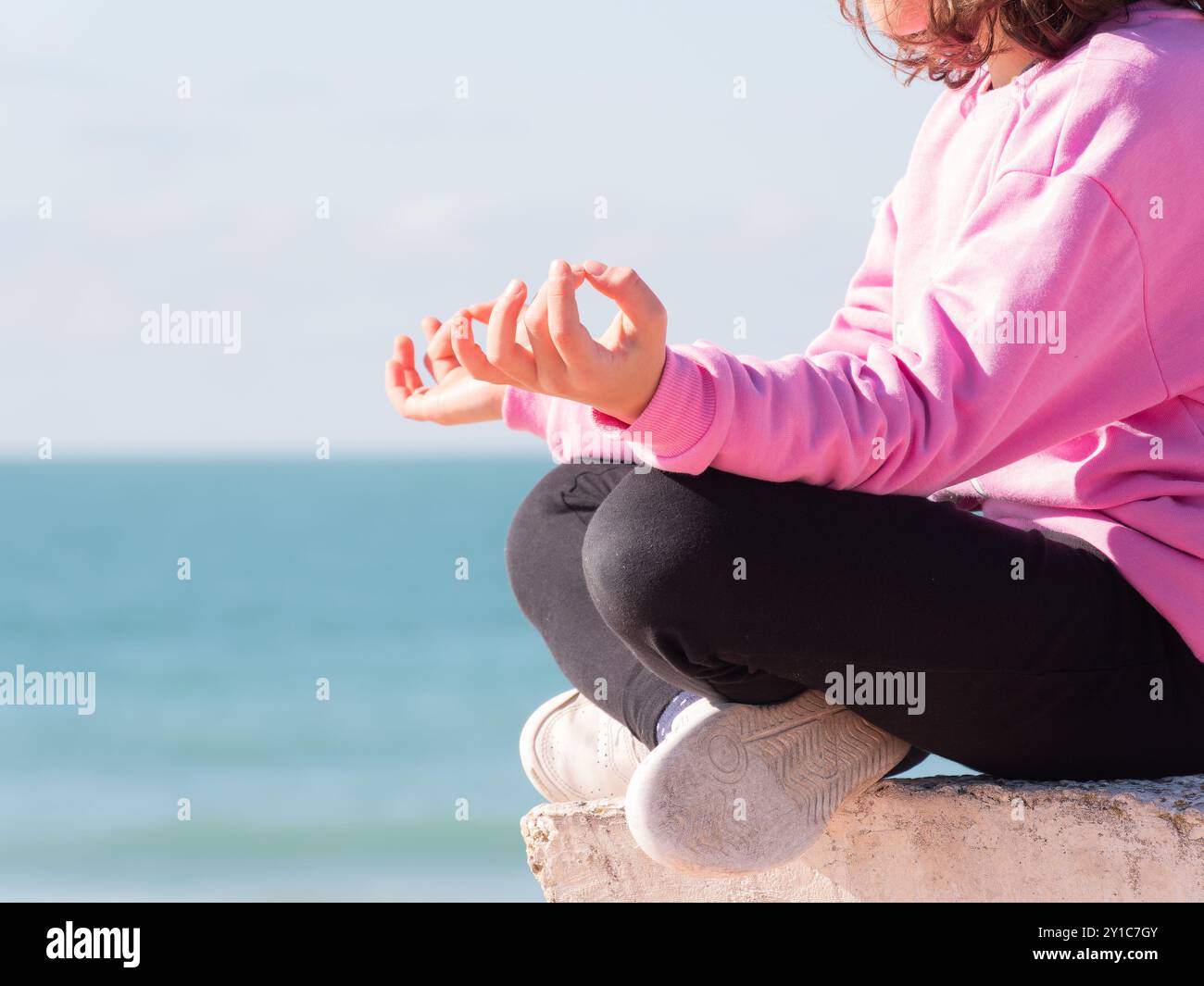 Girl meditating by the sea hi-res stock photography and images - Alamy