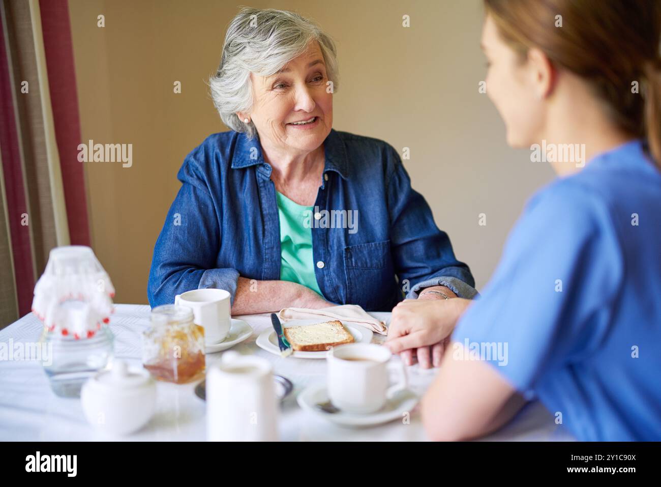 Breakfast, nurse and smile of old woman in dining room of retirement ...