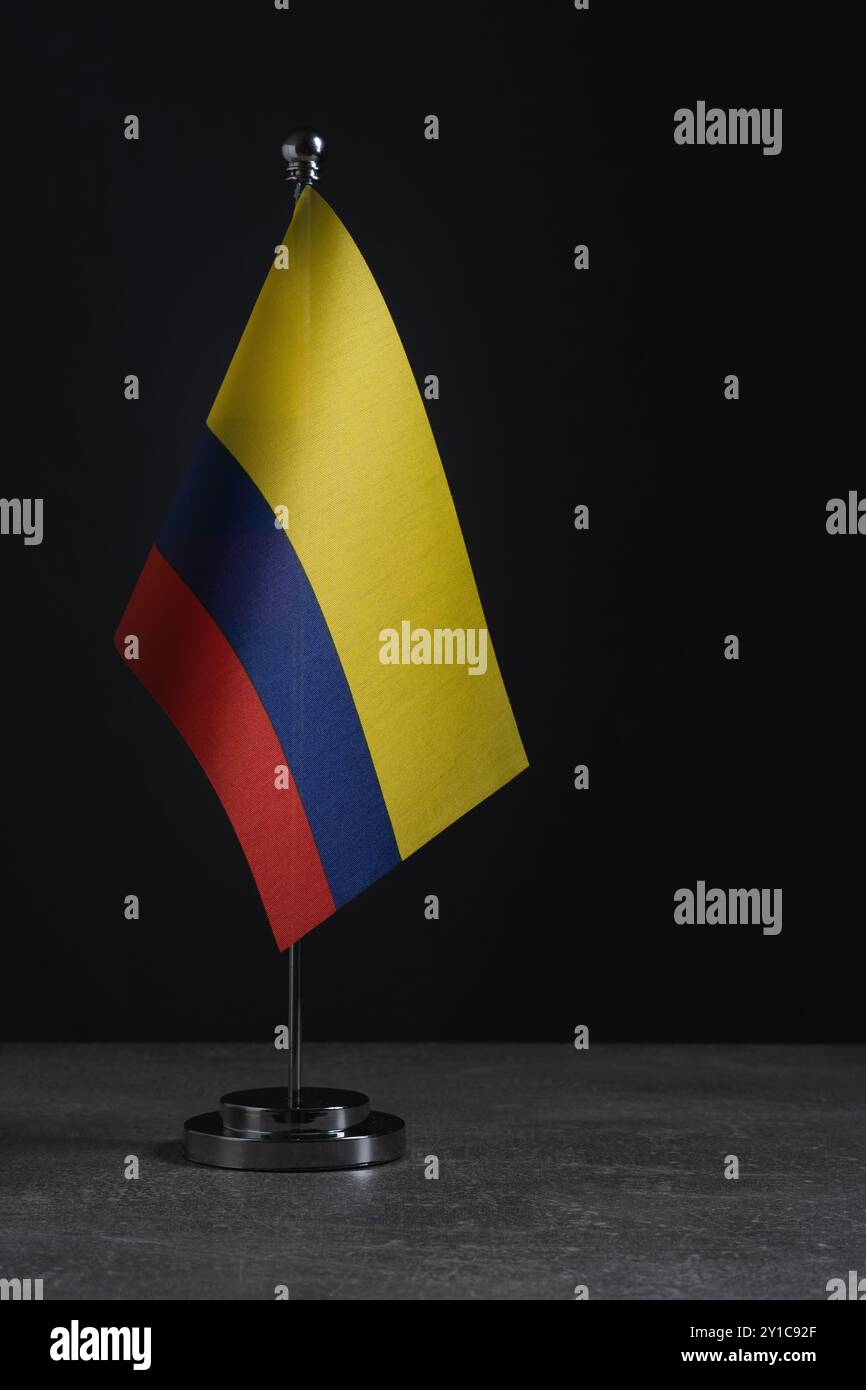 Colombia Flag Stand on Gray Table, Isolated On Black Background Stock ...
