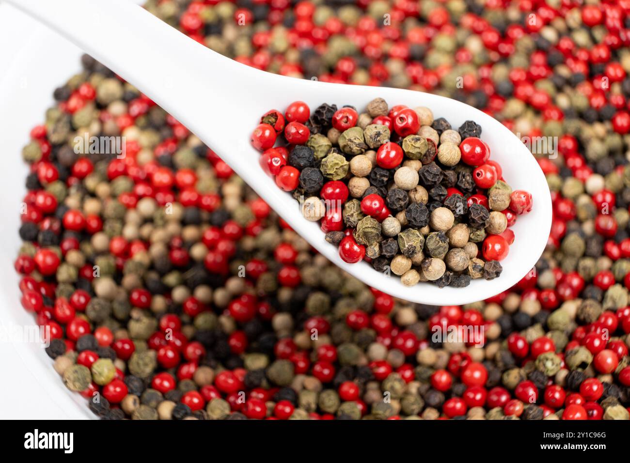 Different varieties of peppercorns, red, green, black and white peppers ...