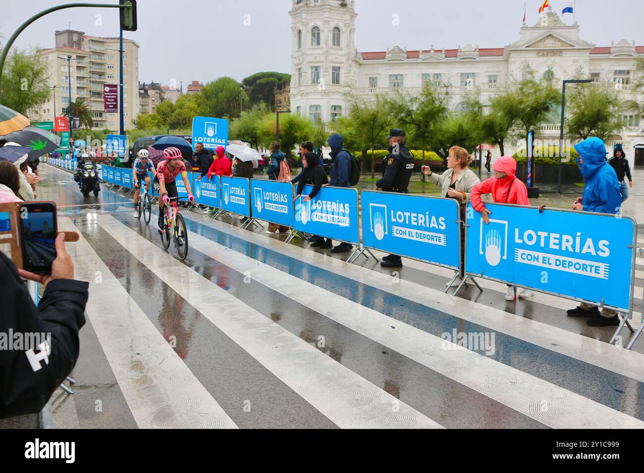 Cyclists competing in the 17th stage of the Vuelta de Espana in pouring ...