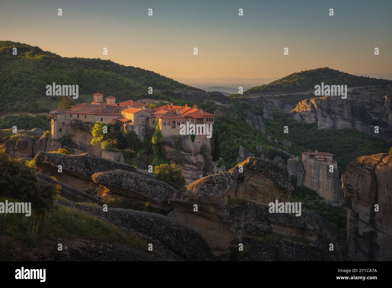 Meteora Monastery illuminated by golden hour light in Greece Stock ...