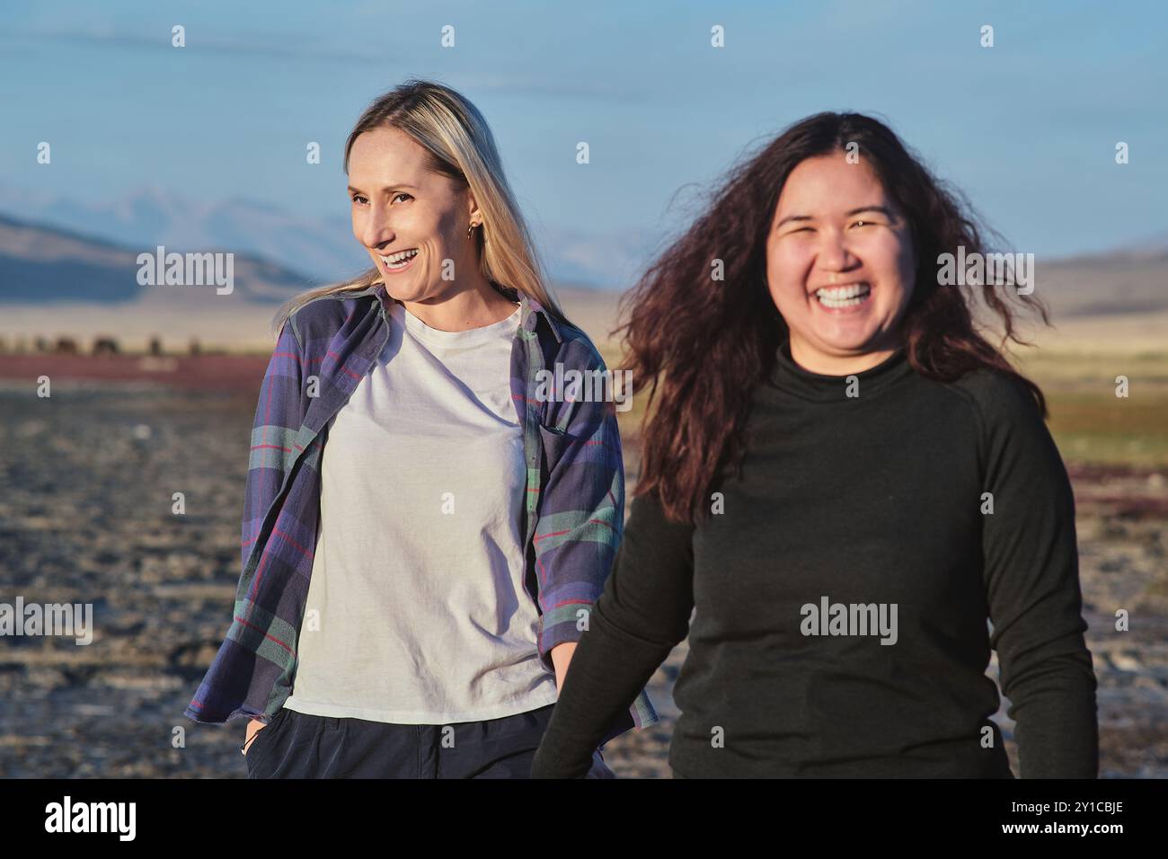 Two smiling women friends walking hi-res stock photography and images ...