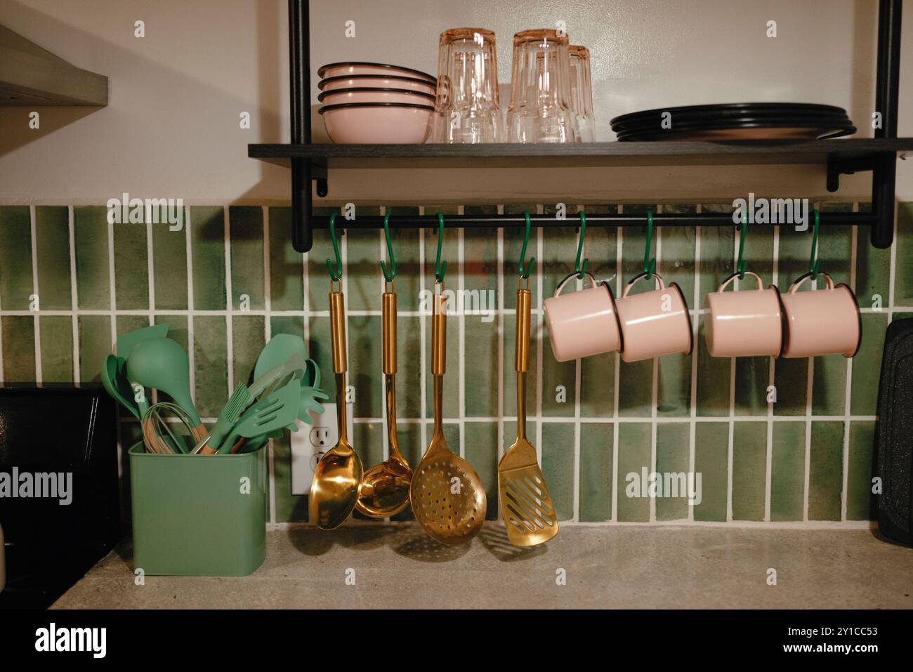 Kitchen countertop with utensils, mugs, and neatly stacked dishes Stock ...